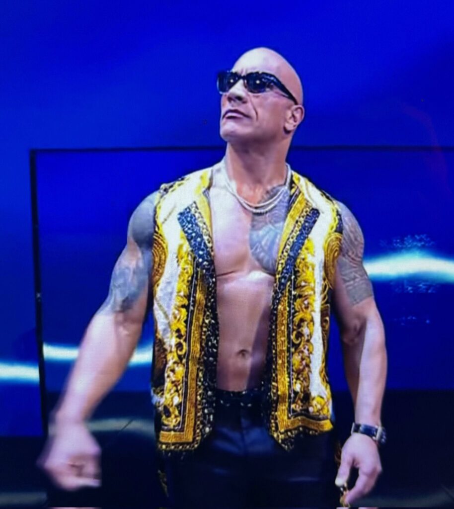 Fans Buzzing Over The Rock’s Bold Versace Look on SmackDown – Thick Accent
